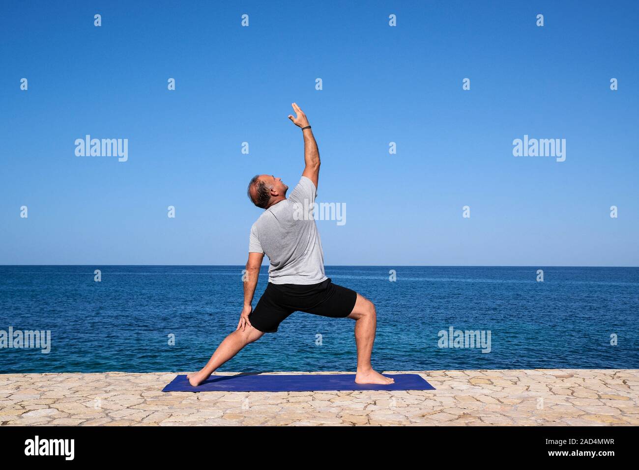 Yoga by the sea. Man practicing yoga by the Caribbean Sea. Photographed ...