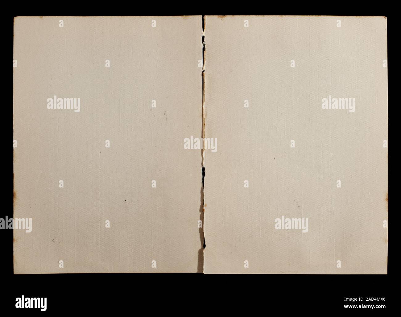 Antique book unfolded showing textured pages isolated on black ...