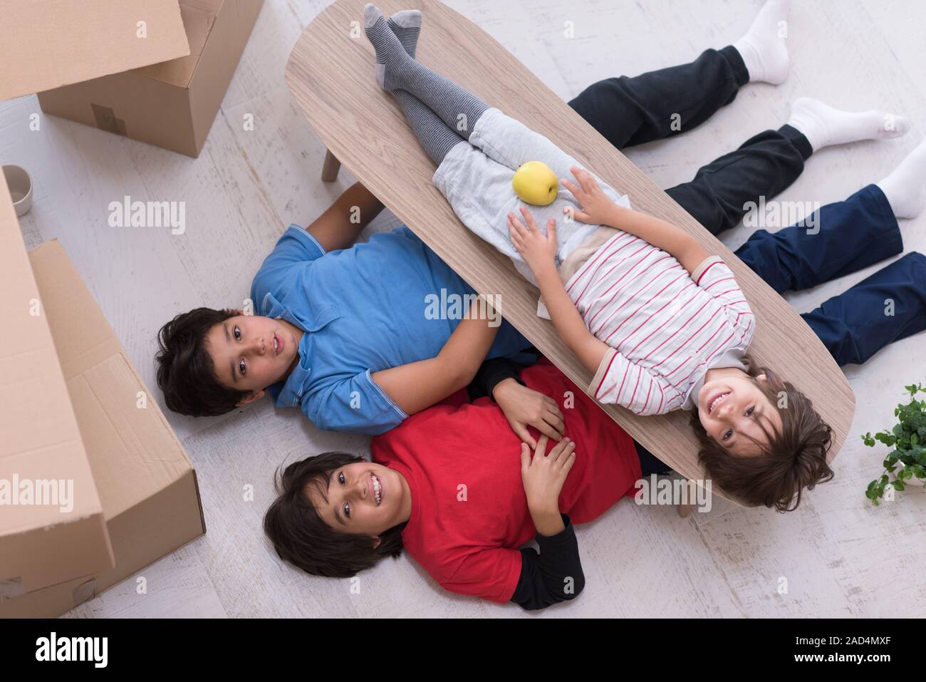boys with cardboard boxes around them top view Stock Photo - Alamy