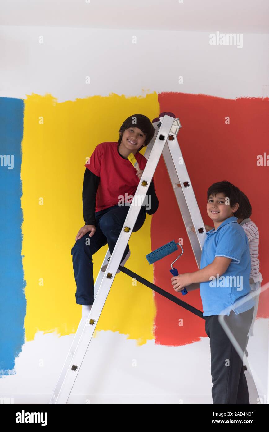 boys painting wall Stock Photo - Alamy