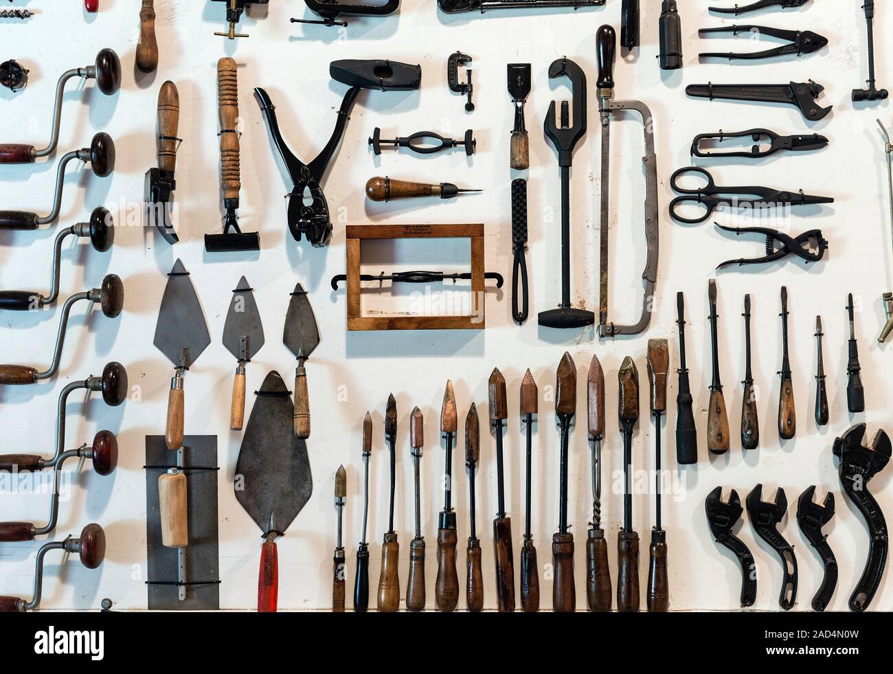 Antique tool collection. Selection of antique tools displayed on a wall ...