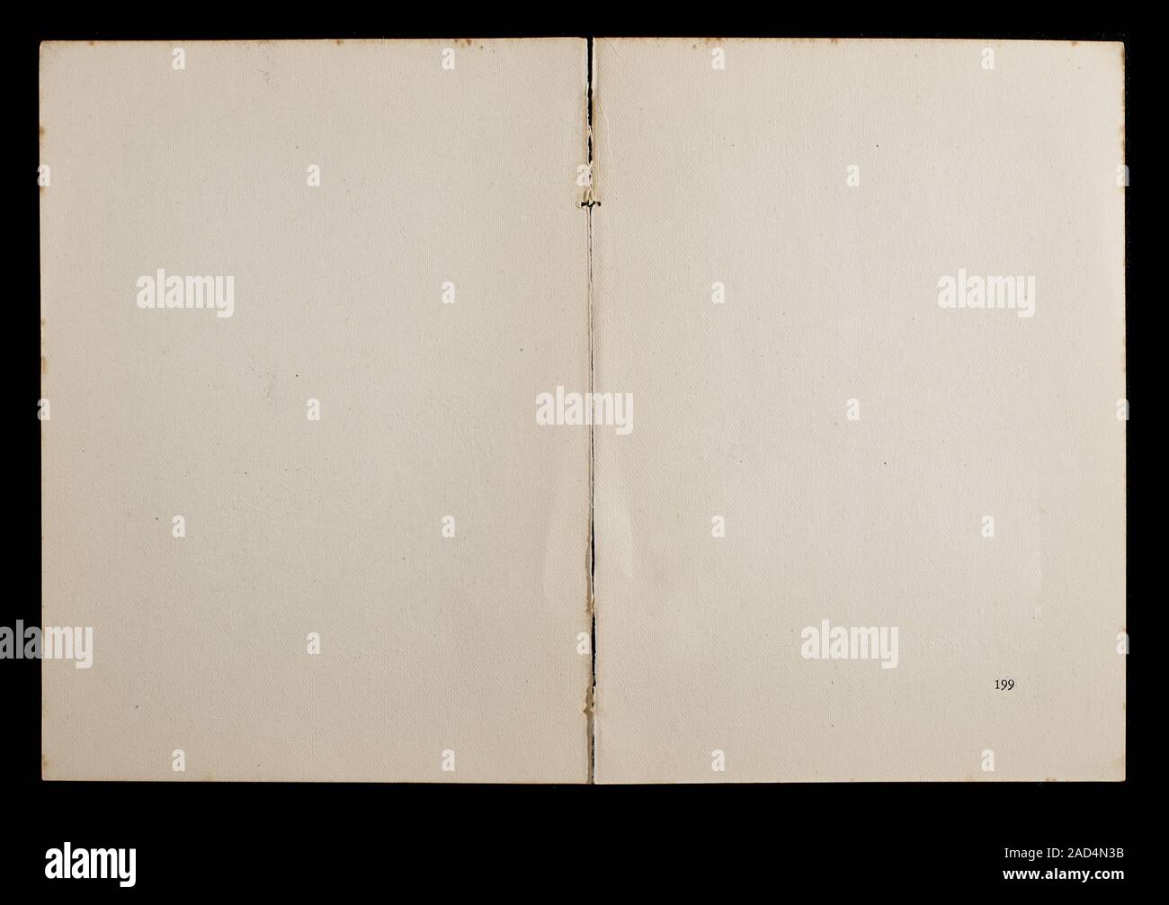 Antique book unfolded showing textured pages isolated on black ...