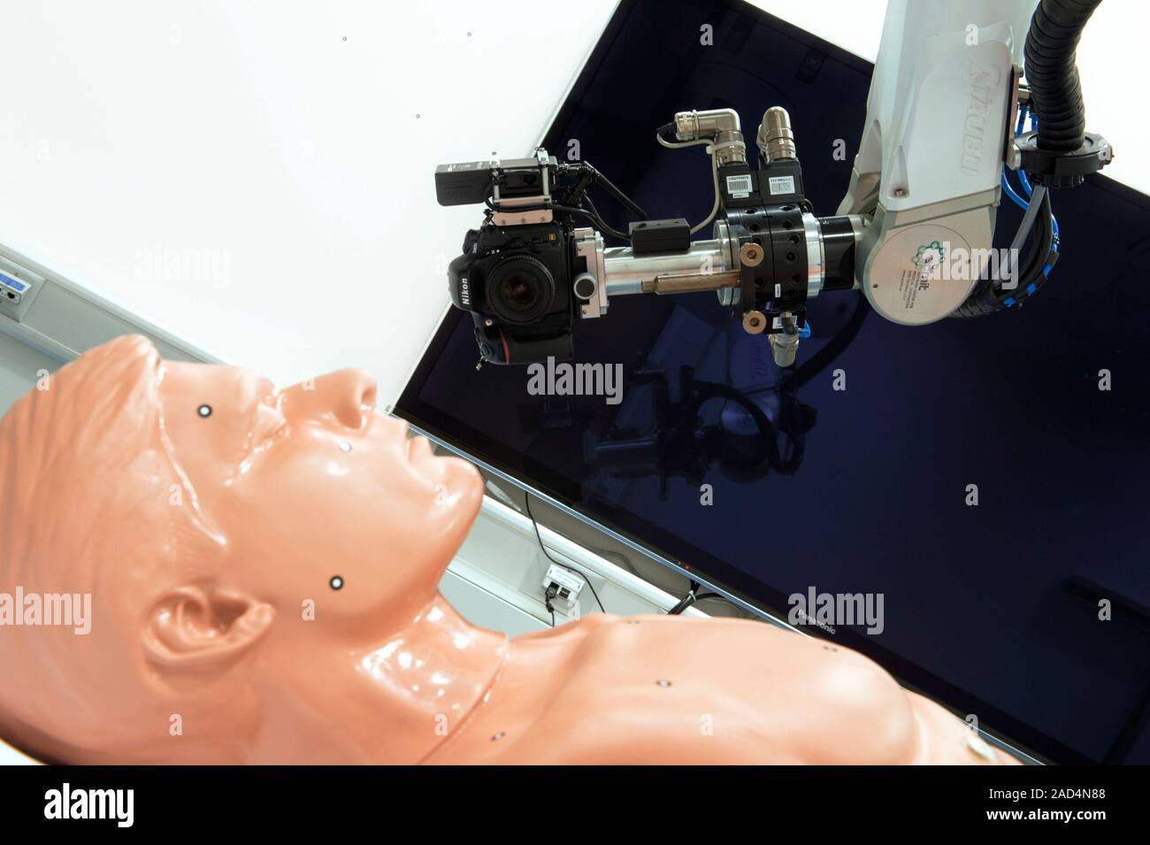 Virtopsy robot scanner. Mannequin corpse being scanned by the Virtopsy ...