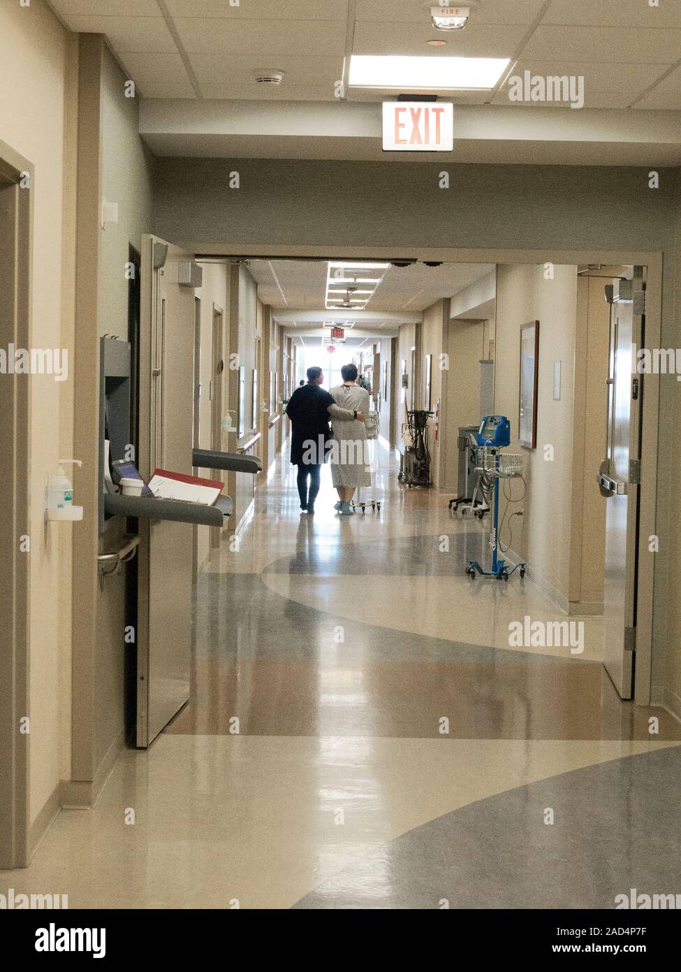 Patient in a hospital. Patient walking in hospital corridor Stock Photo ...
