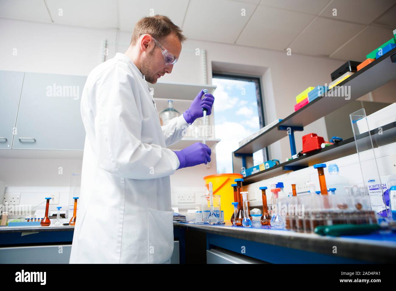 Drug manufacturing. Laboratory worker producing drugs at a ...