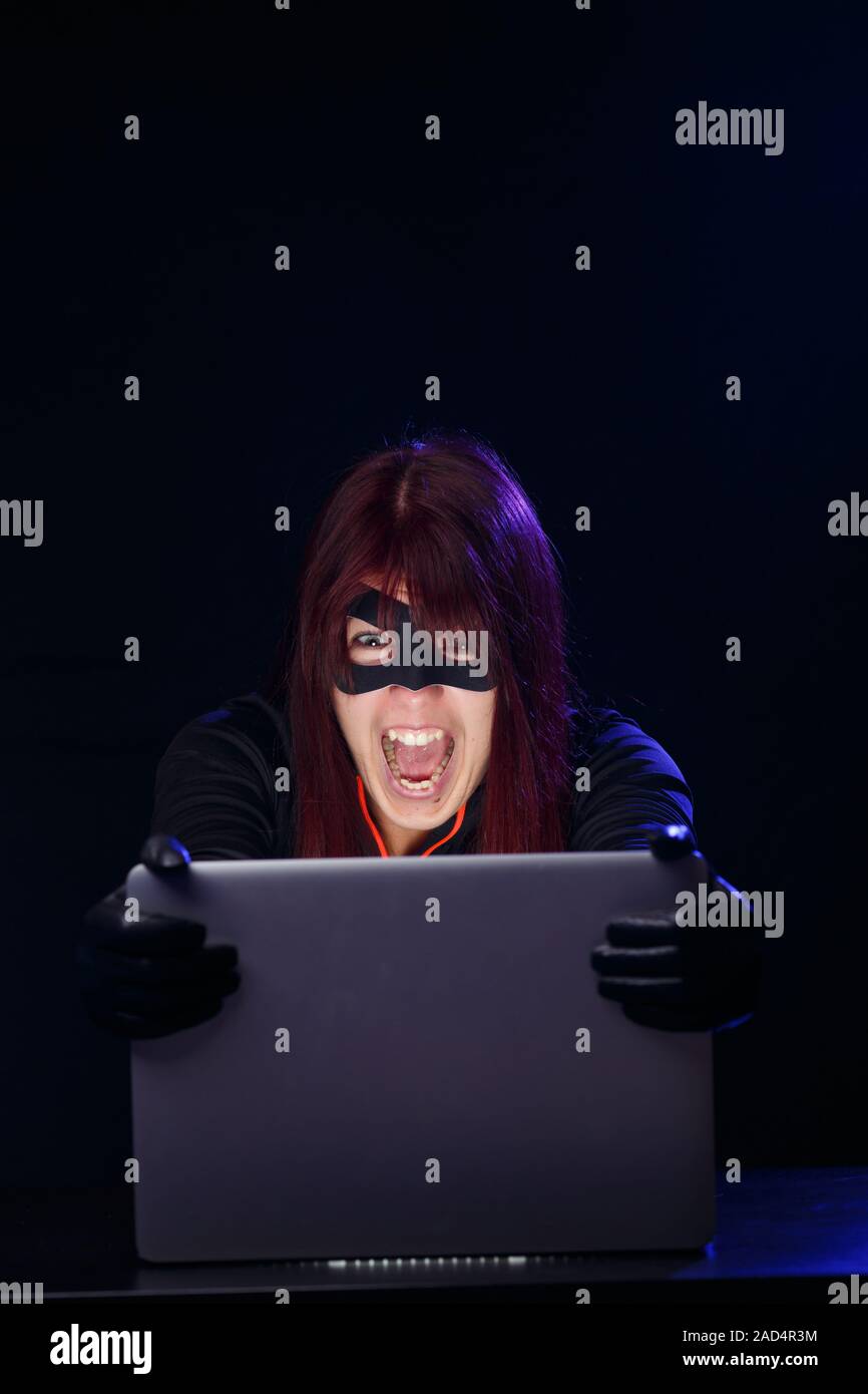 Screaming girl hacker at night Stock Photo - Alamy