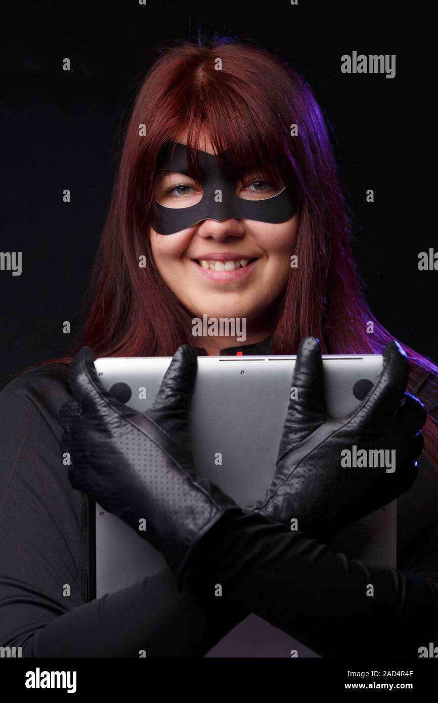 Beautiful hacker in black gloves Stock Photo - Alamy