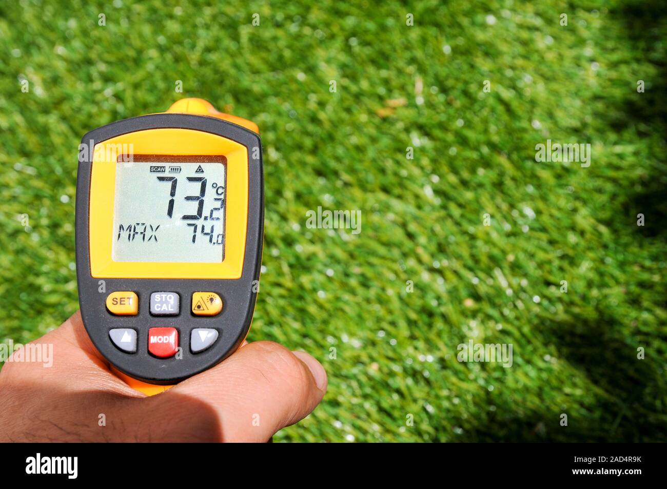 Measuring the temperature of artificial lawn in direct sun - 73 degrees ...