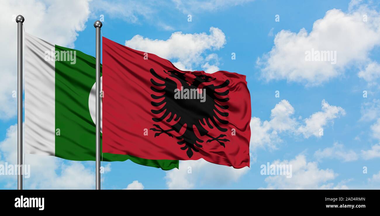 Pakistan and Albania flag waving in the wind against white cloudy blue ...