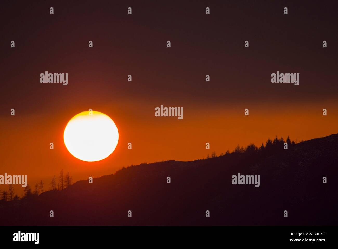 The sun setting over Black Crag in the Lake District, UK Stock Photo ...