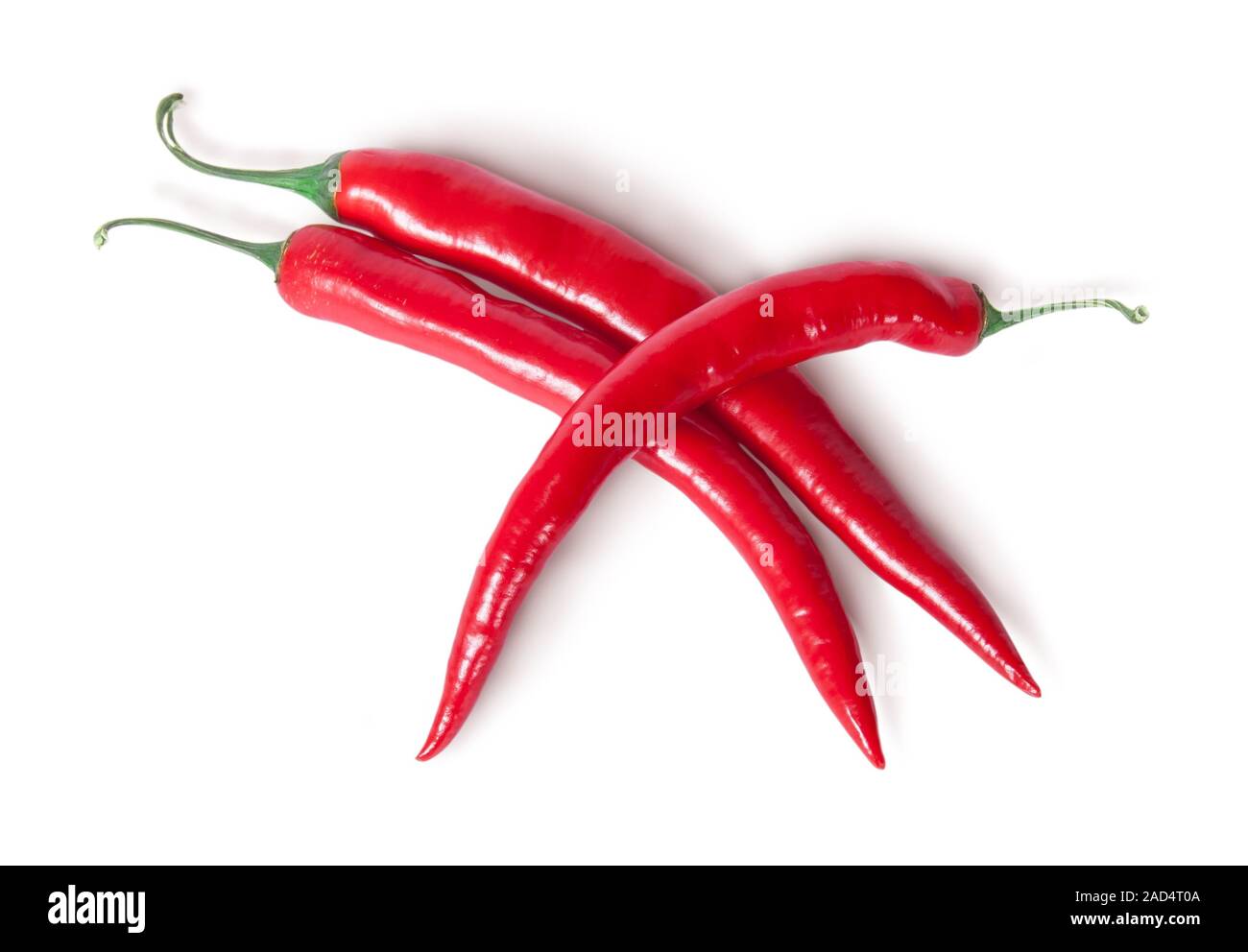 Three red chili peppers crisscross Stock Photo - Alamy