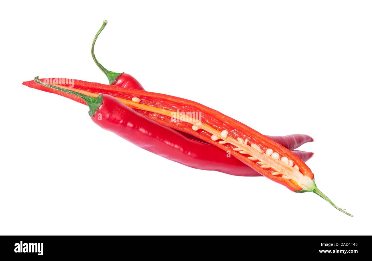 Two whole and one half red chili peppers deployed Stock Photo - Alamy
