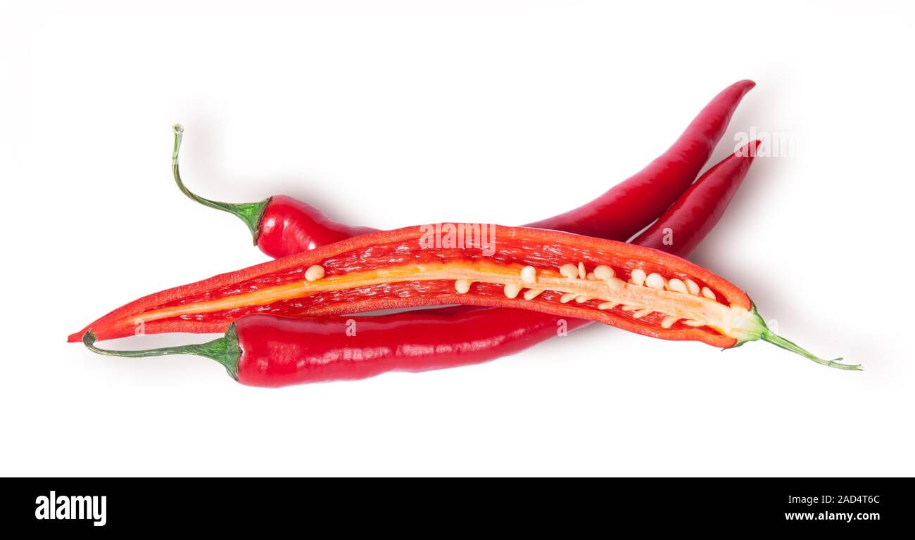 Two whole and one half red chili peppers Stock Photo - Alamy