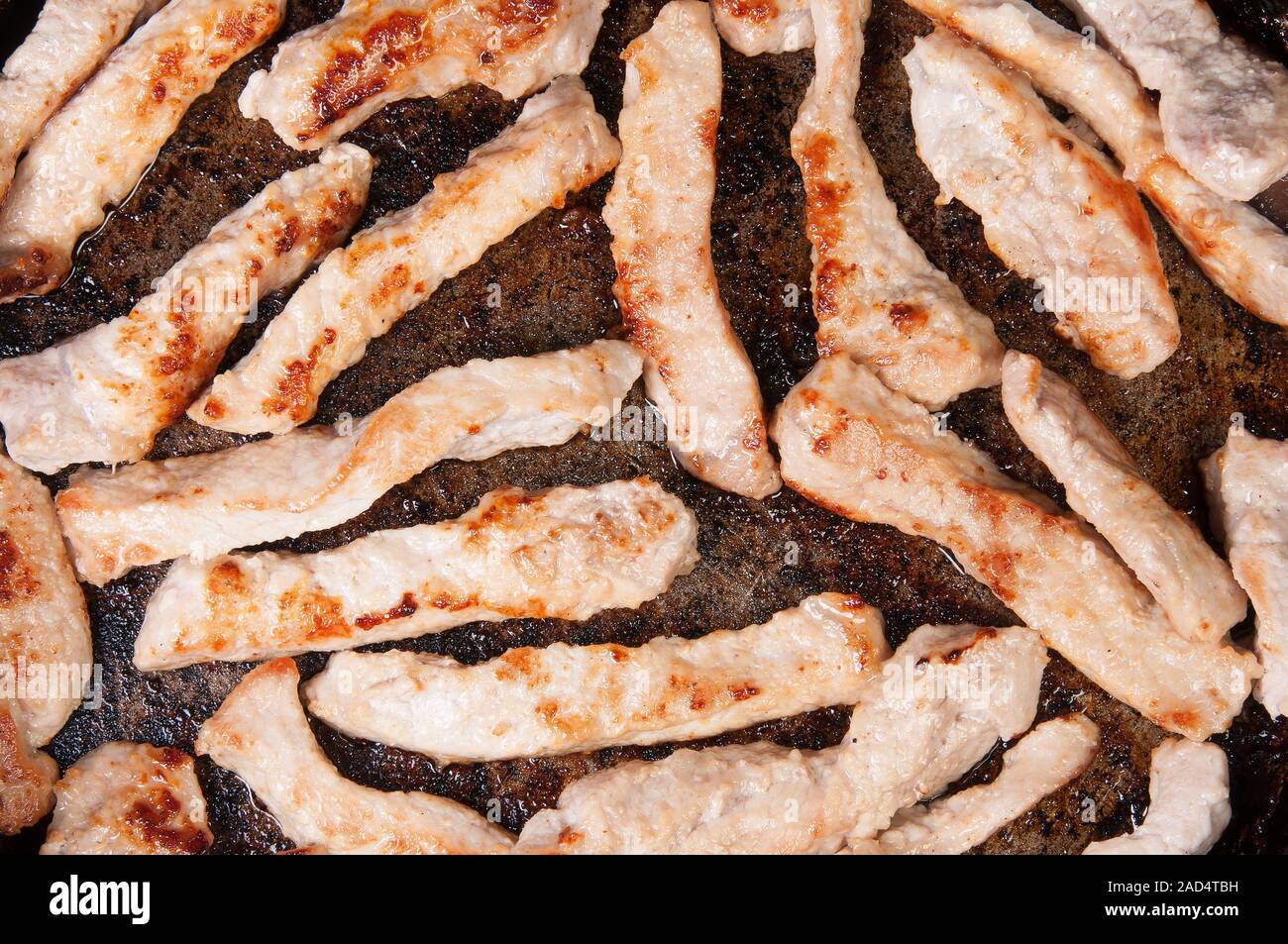 Meat Strips Fried In A Pan Stock Photo - Alamy