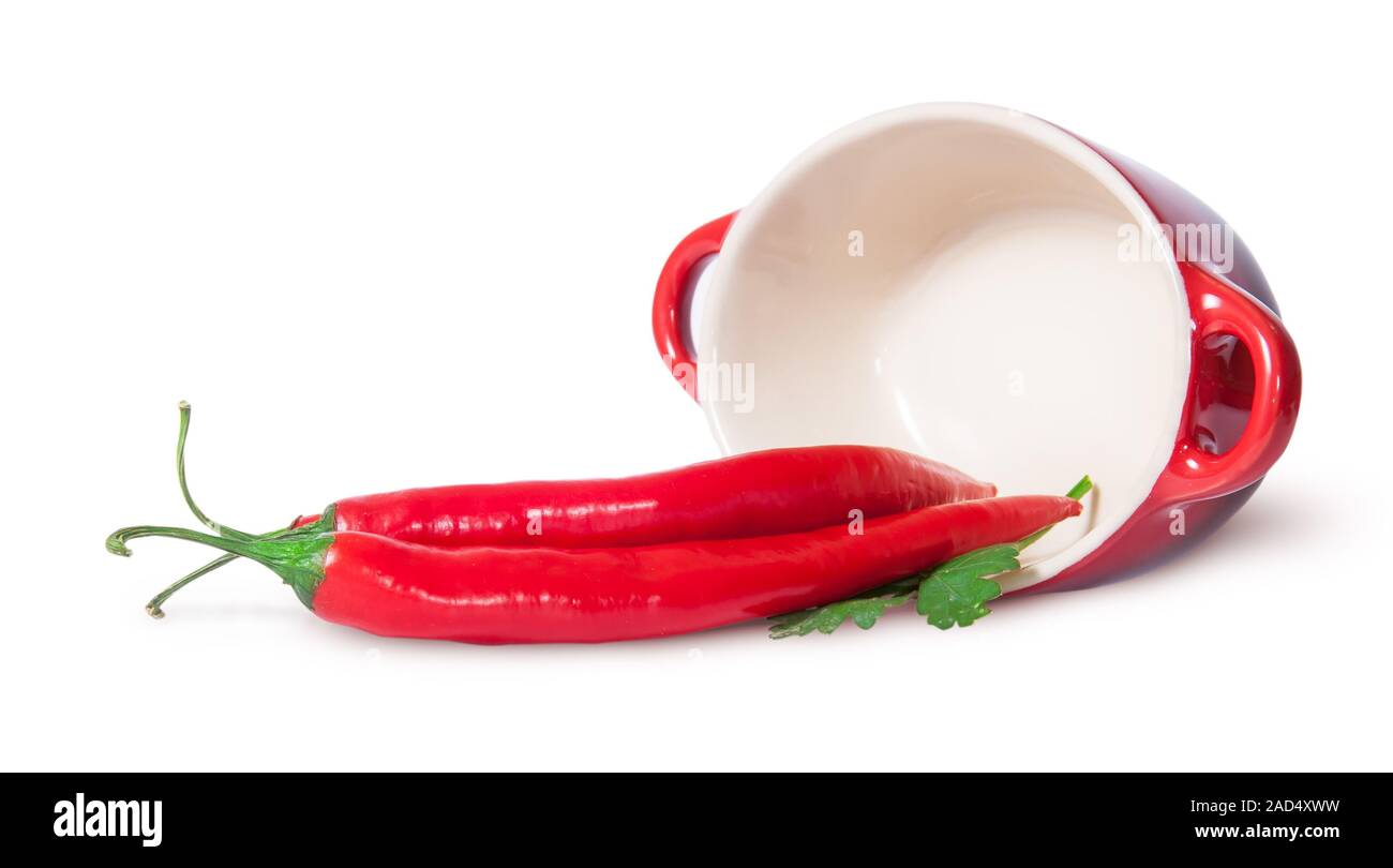 Chili pepper and parsley near inverted pan Stock Photo - Alamy