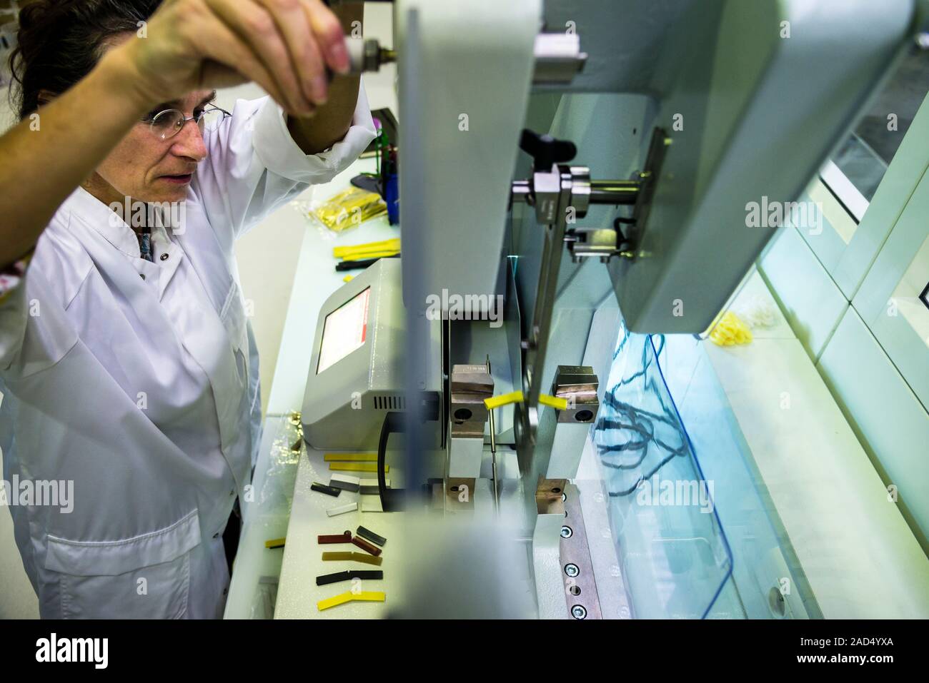Quality control of recycled plastics. A technician conducting shock ...