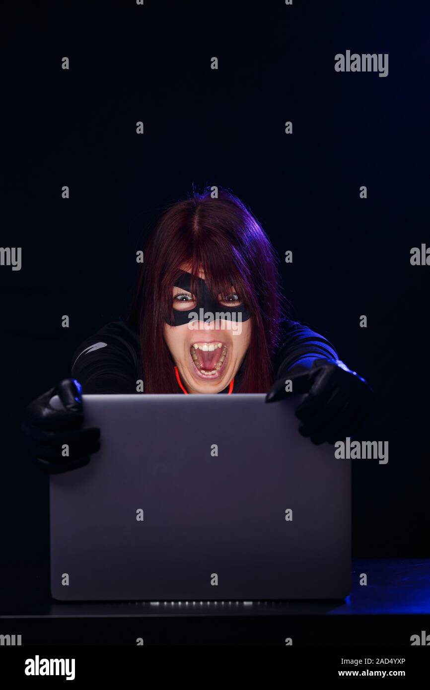 Screaming woman hacker at night Stock Photo - Alamy