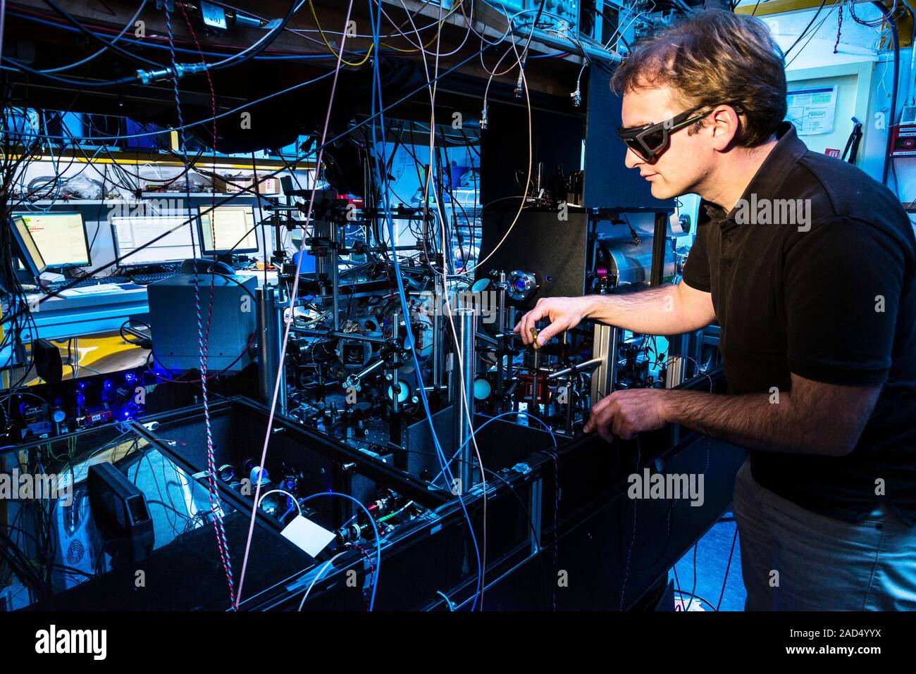 Strontium optical lattice clock research. A researcher aligns a laser ...
