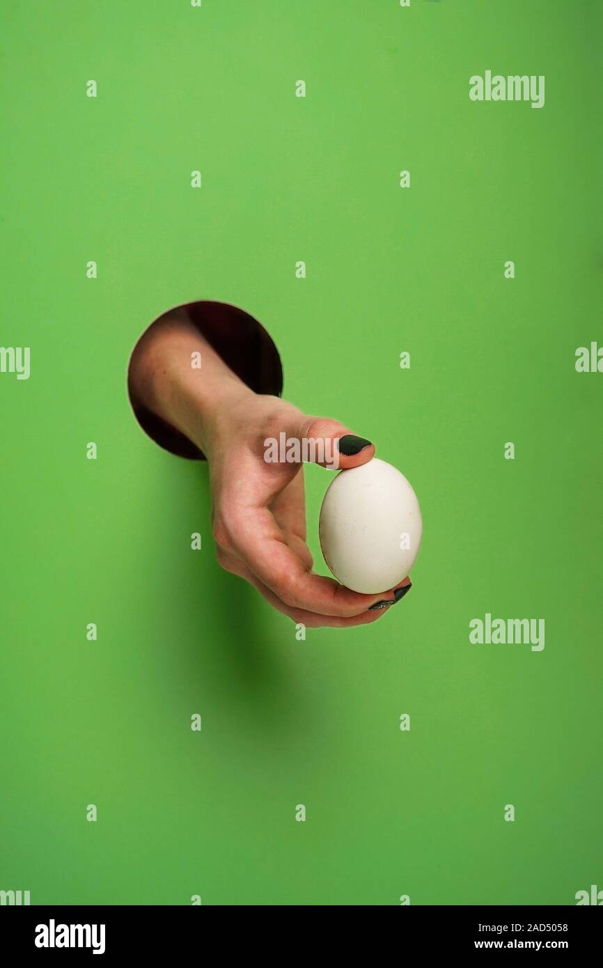 female hand in a circular hole in the background Stock Photo - Alamy