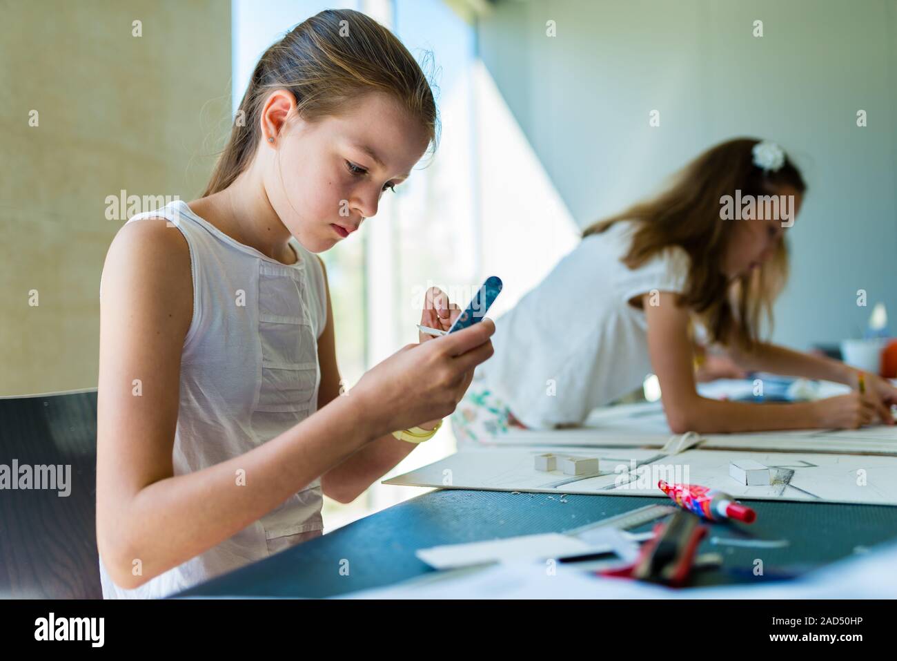 Young girl on the course of architectural design for children ...