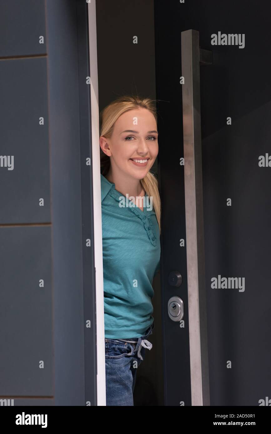 Woman front door open entering home hi-res stock photography and images ...