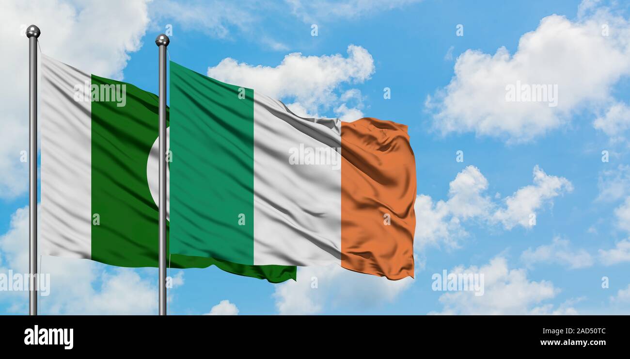 Pakistan and Ireland flag waving in the wind against white cloudy blue ...