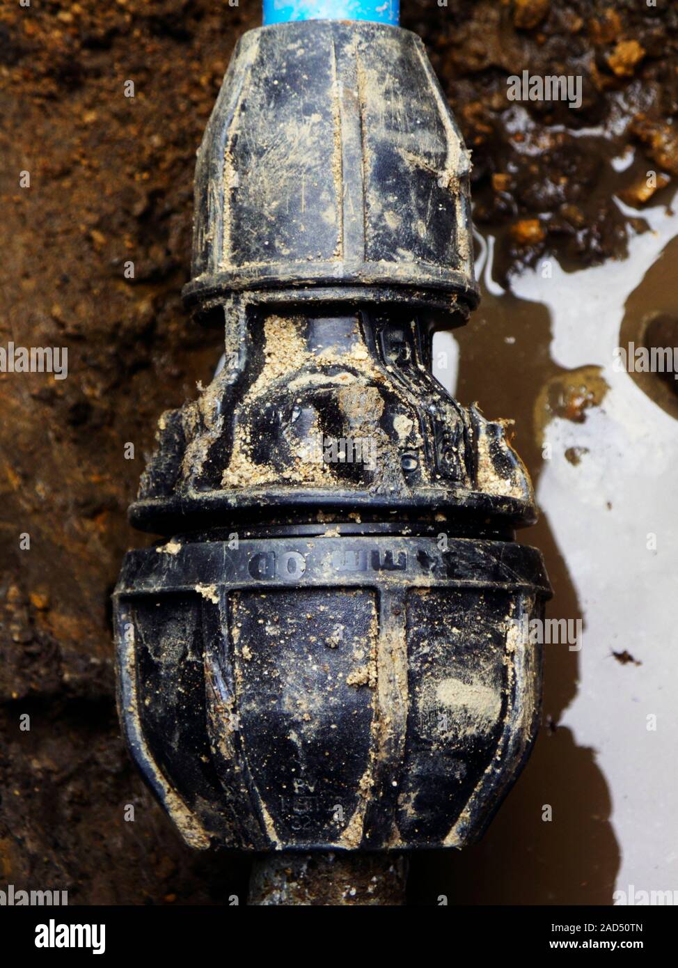 Water pipe fitting. Close-up of a plastic connector on a domestic water ...
