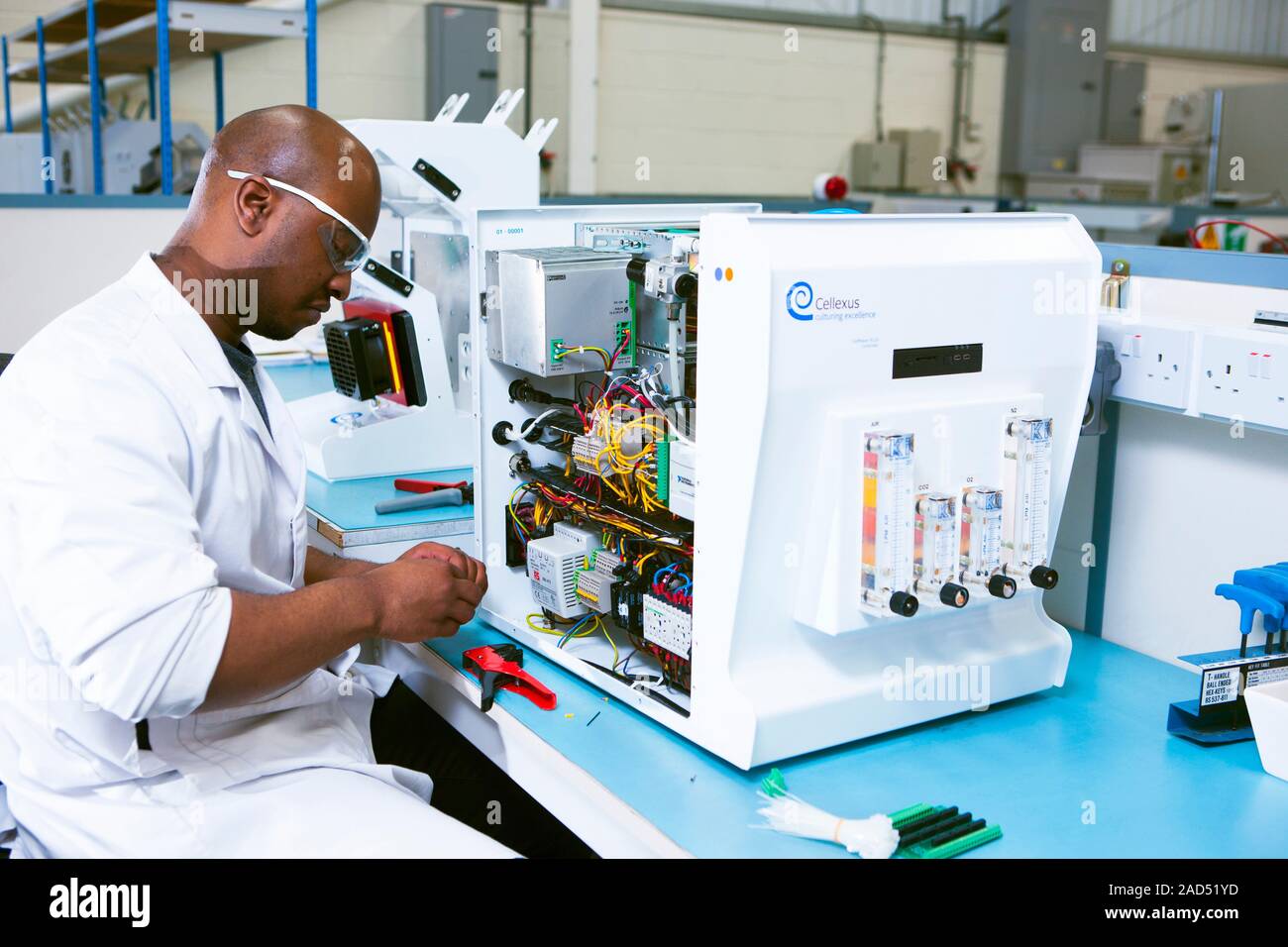 Bioreactor construction. Technician building a bioreactor system. This ...