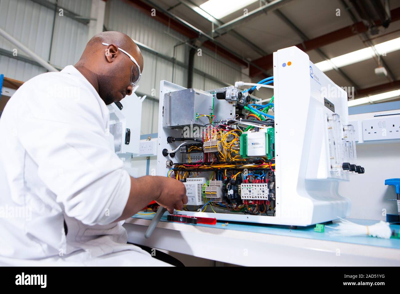 Bioreactor construction. Technician building a bioreactor system. This ...