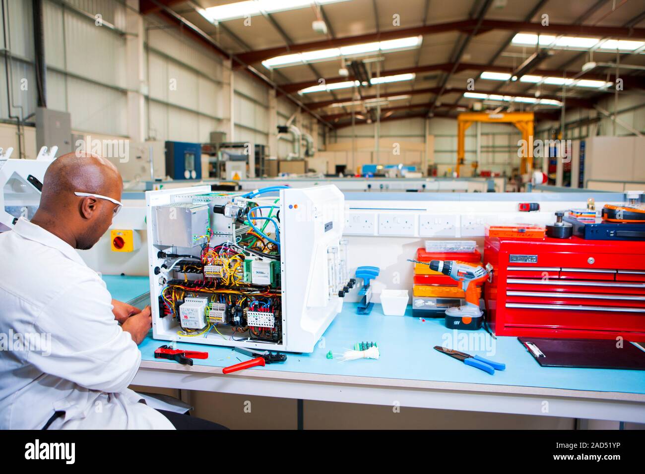 Bioreactor construction. Technician building a bioreactor system. This ...