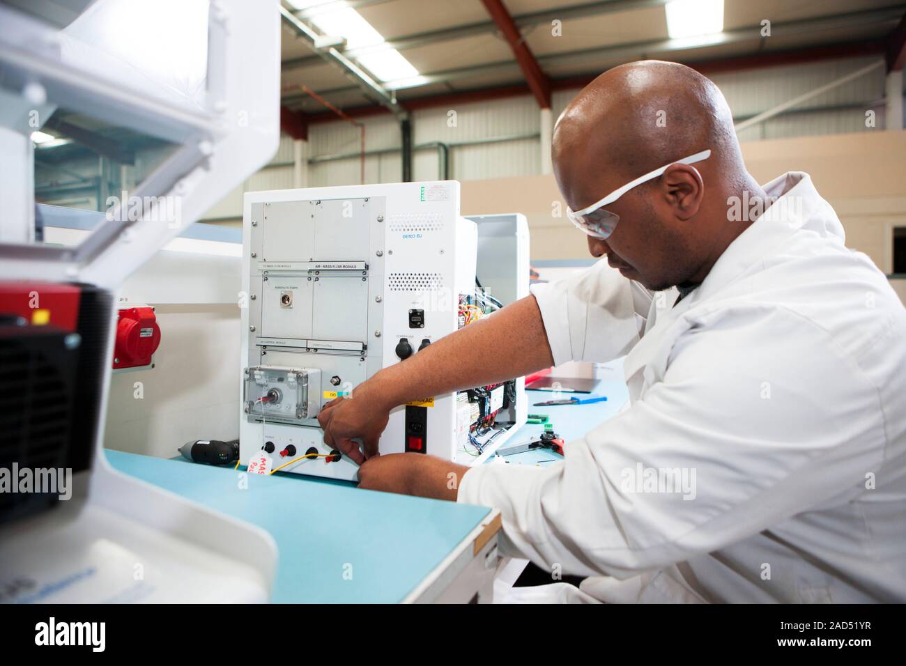 Bioreactor construction. Technician building a bioreactor system. This ...