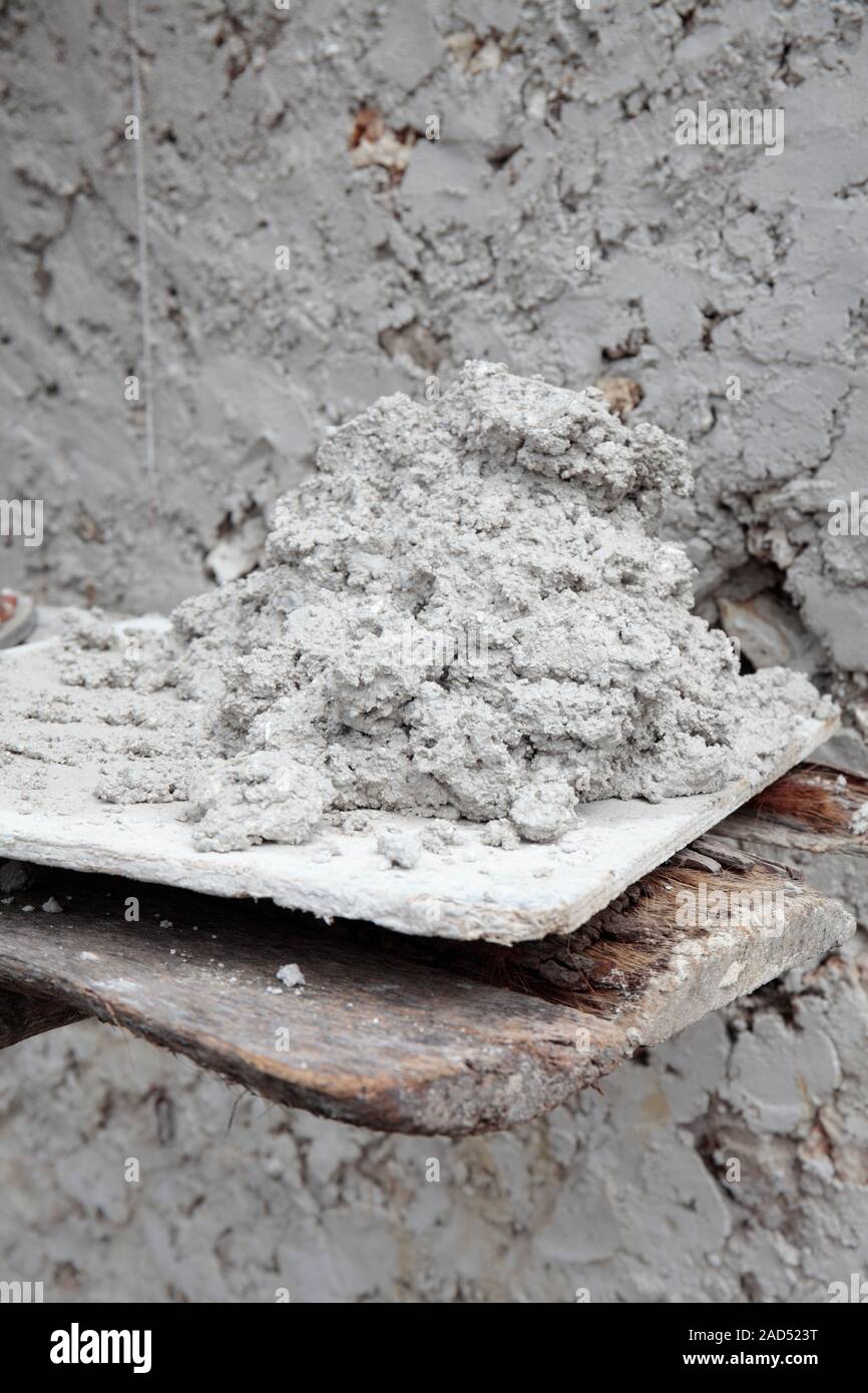 Coral cement. Close-up of cement made from powdered coral, being used ...