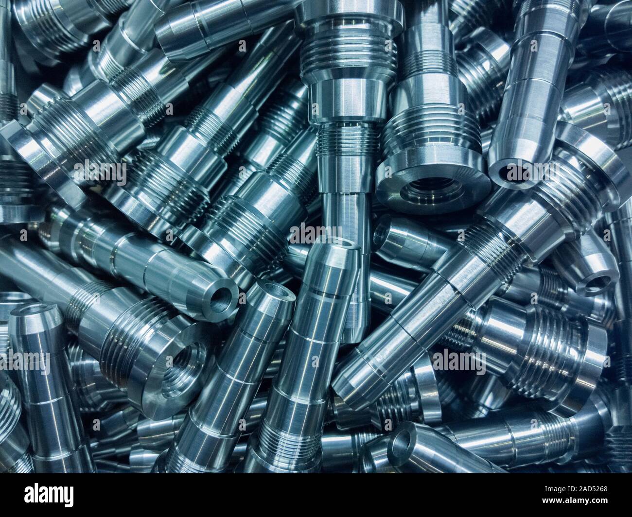 shiny steel parts background, apile of long steel rods after modern ...