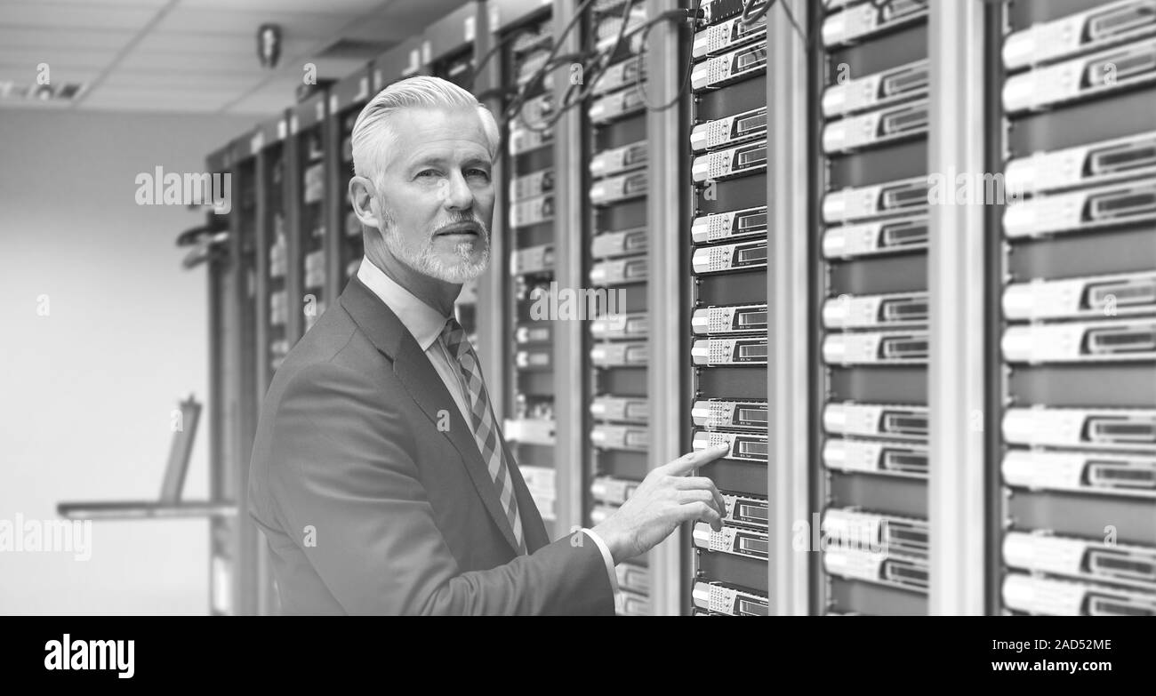 Senior Businessman in server room Stock Photo - Alamy