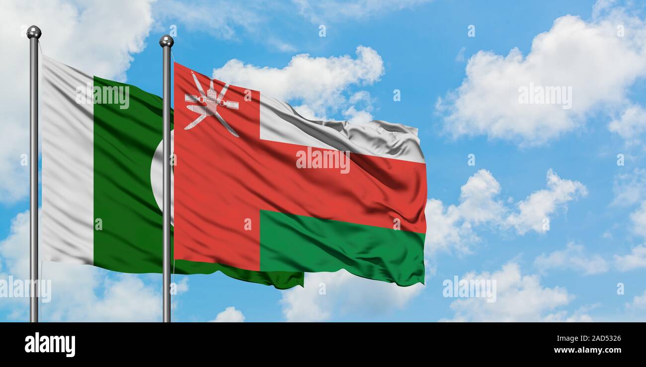 Pakistan and Oman flag waving in the wind against white cloudy blue sky ...