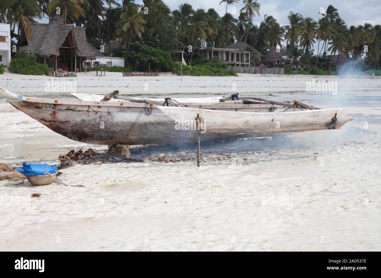 Fire-hardening a ngalawa boat, Zanzibar. Ngalawa boat being hardened ...