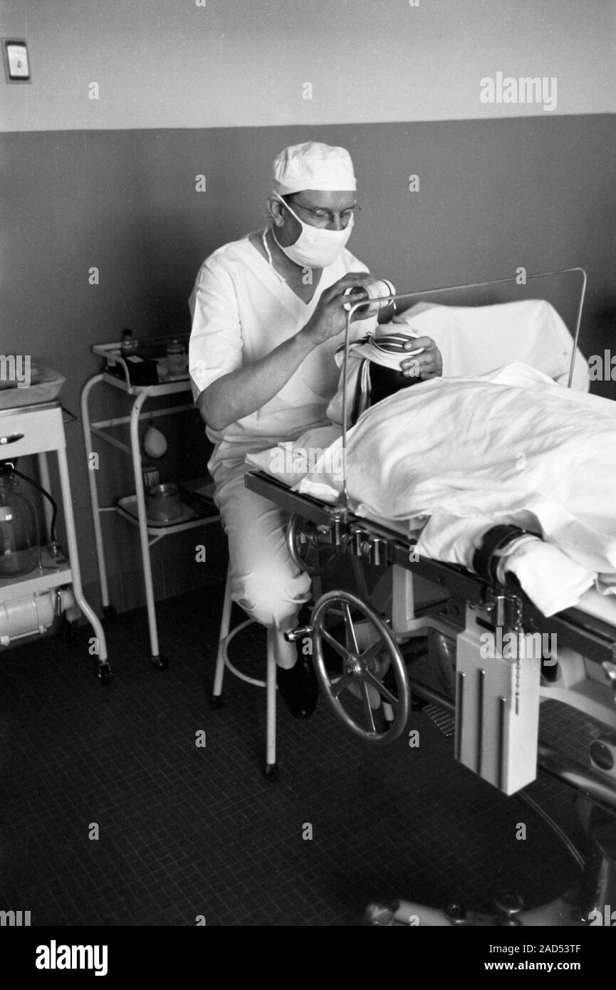 Anaesthesia in surgery. Anaesthetist applying anaesthetic to a patient ...