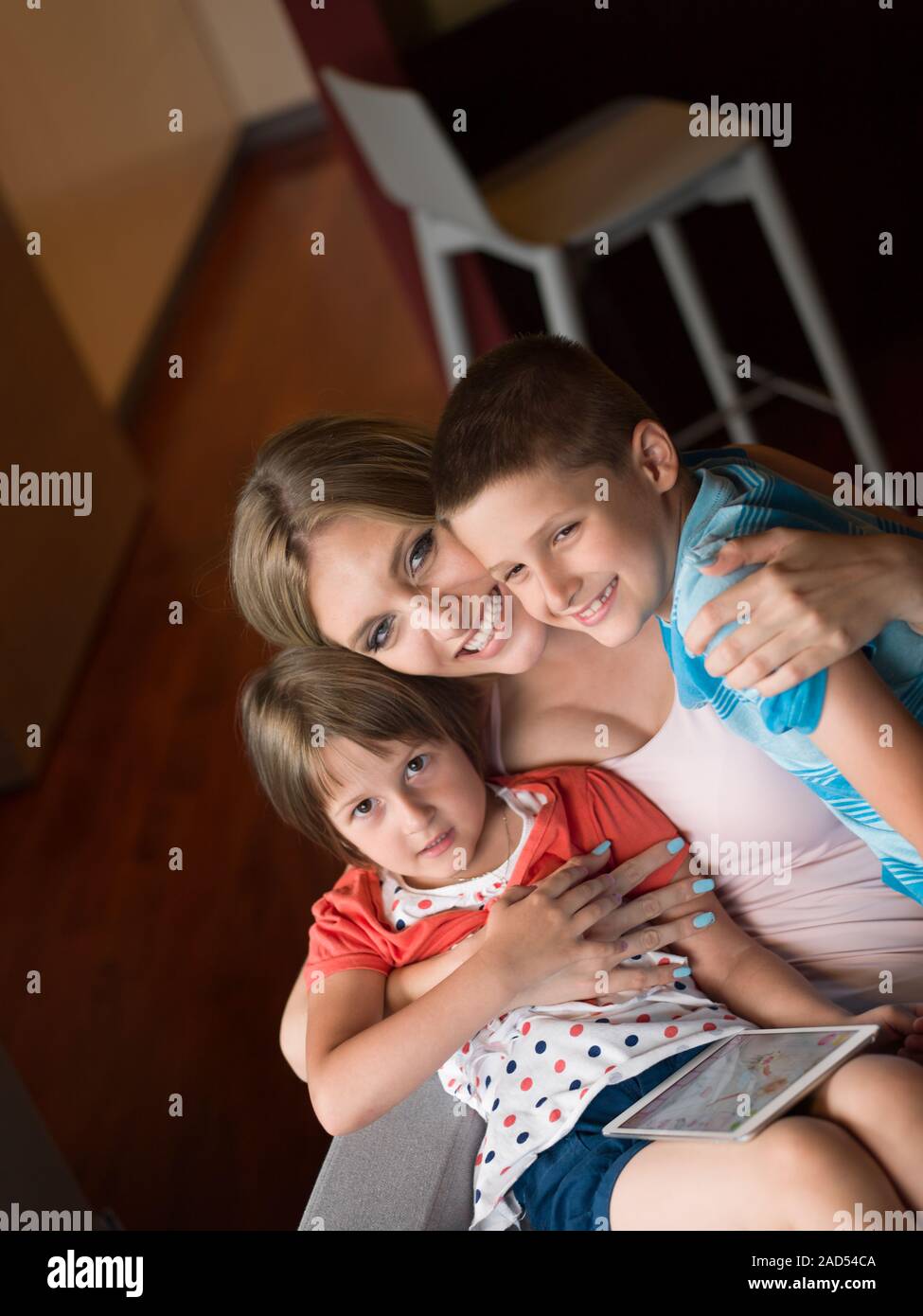 Young Family Using A Tablet To Make Future Plans Stock Photo - Alamy