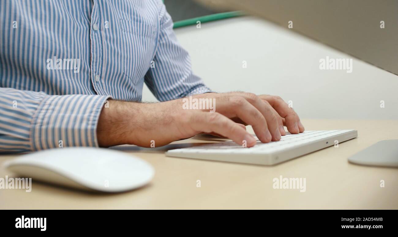 hands typing on computer keyboard in startup office Stock Photo - Alamy