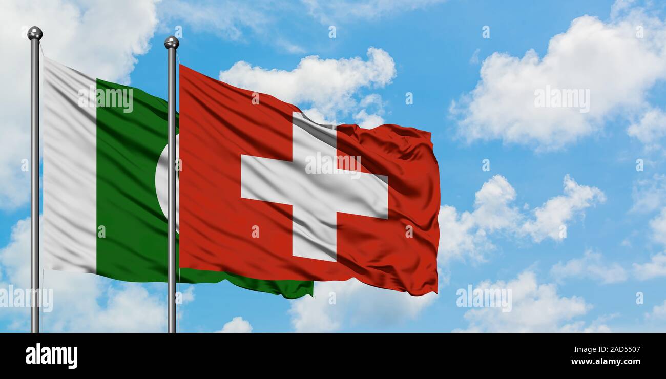 Pakistan and Switzerland flag waving in the wind against white cloudy ...