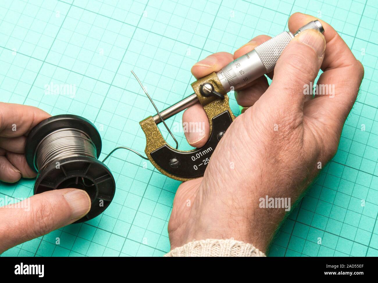 Micrometer measuring wire. A micrometer being used to measure the ...