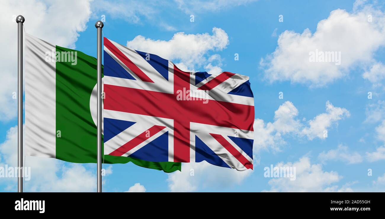 Pakistan and United Kingdom flag waving in the wind against white ...