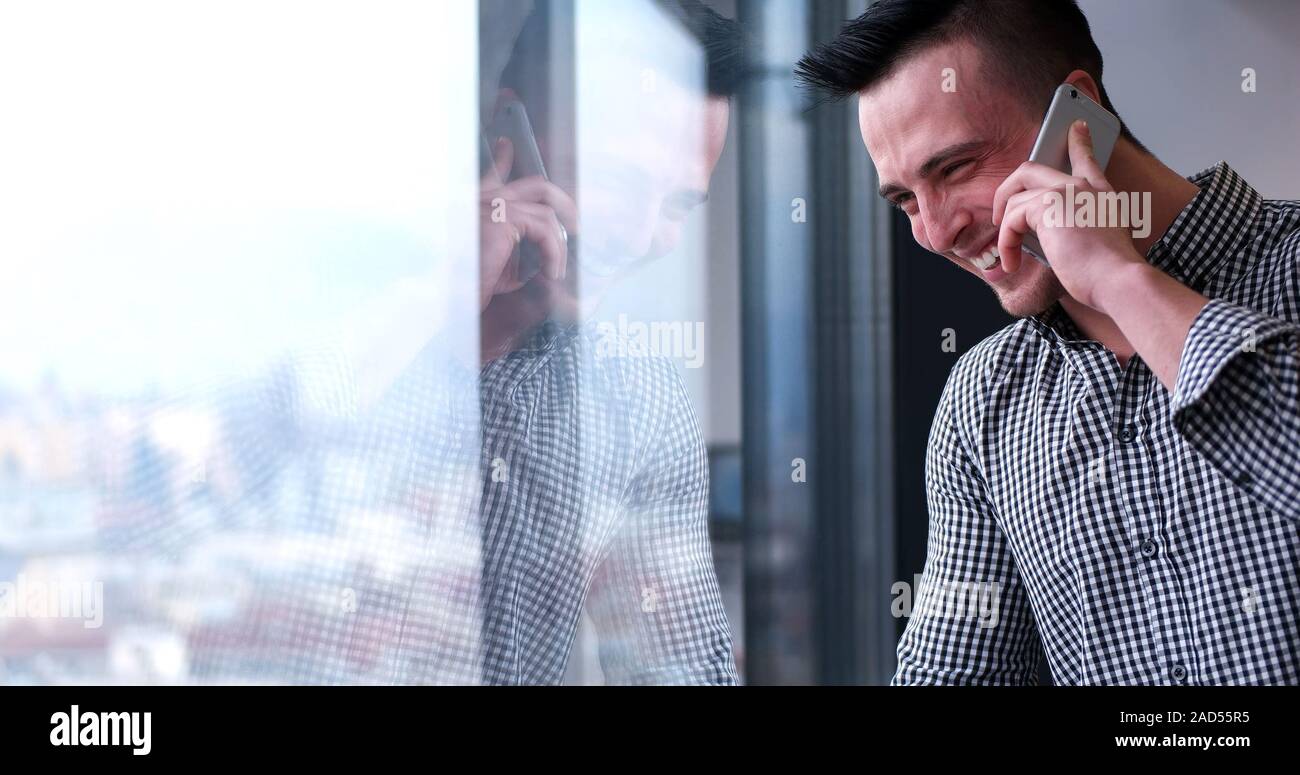 Business Man Talking On Cell Phone, Looking Out Office Window Stock ...