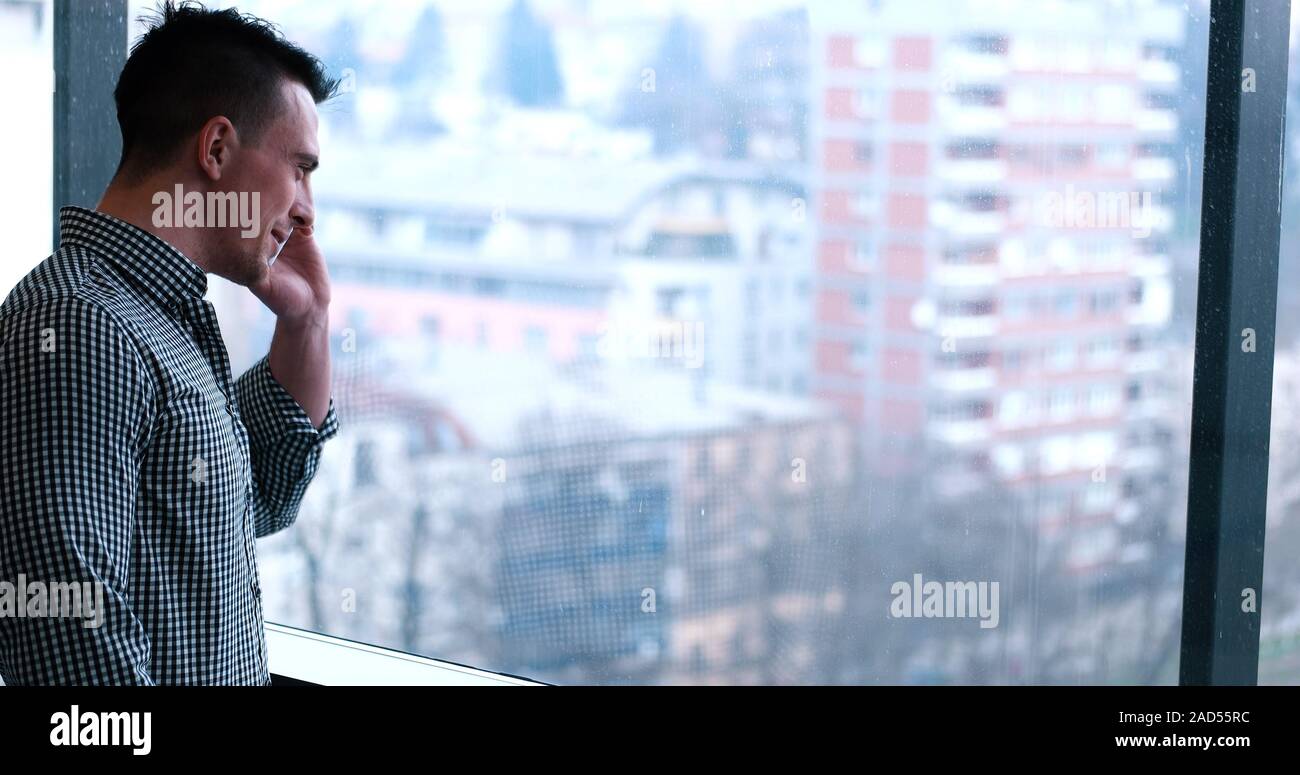 Business Man Talking On Cell Phone, Looking Out Office Window Stock ...