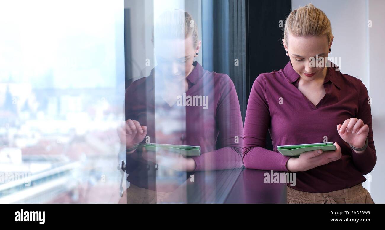 woman manager using cell telephone in office interior Stock Photo - Alamy