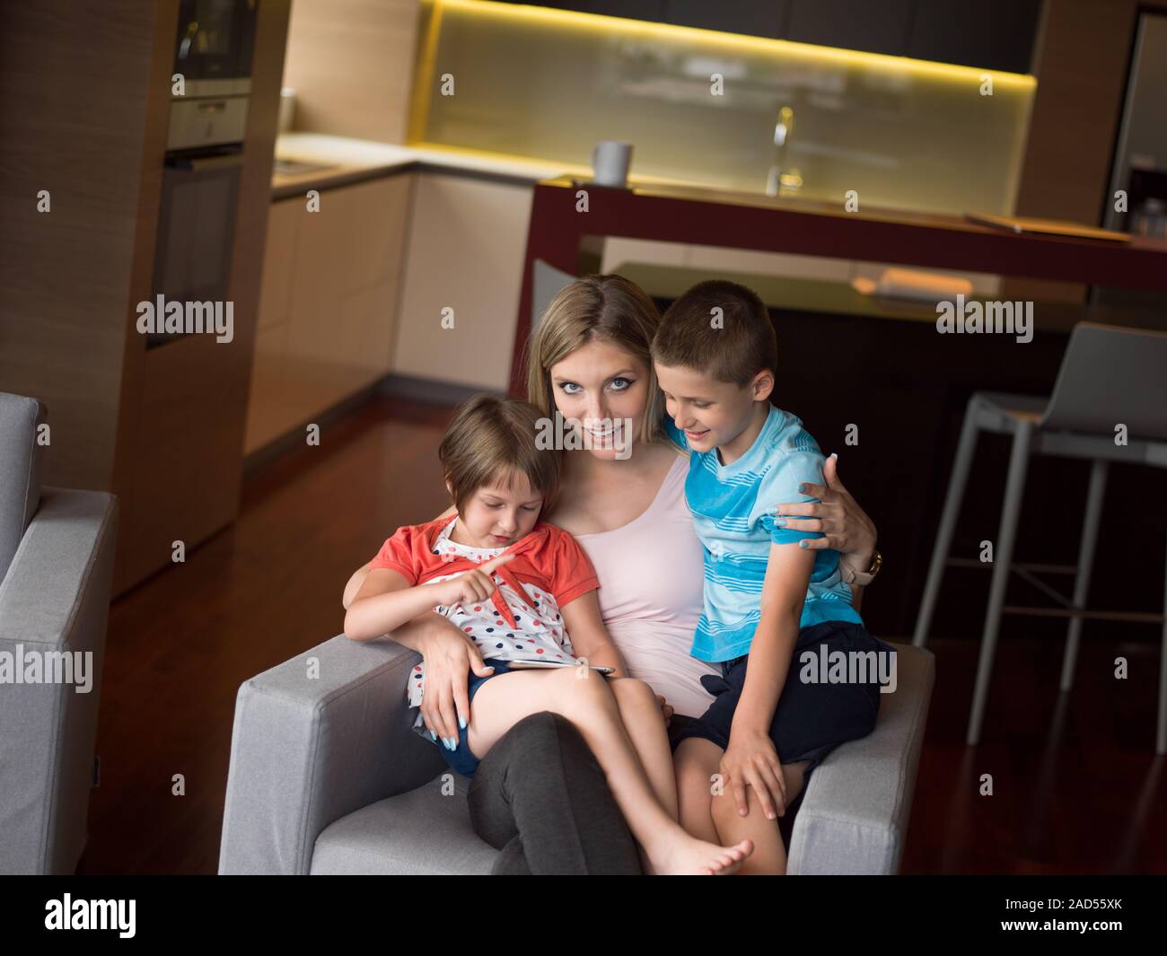 Young Family Using A Tablet To Make Future Plans Stock Photo - Alamy