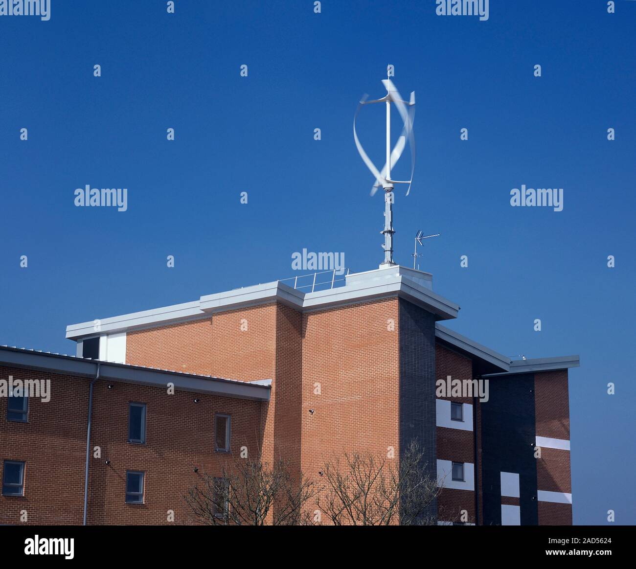 Vertical axis wind turbine on the roof of a block of flats. The triple ...