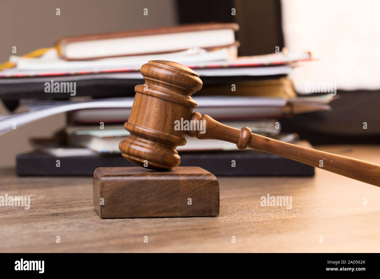 Paper, hammer on wooden table Stock Photo - Alamy