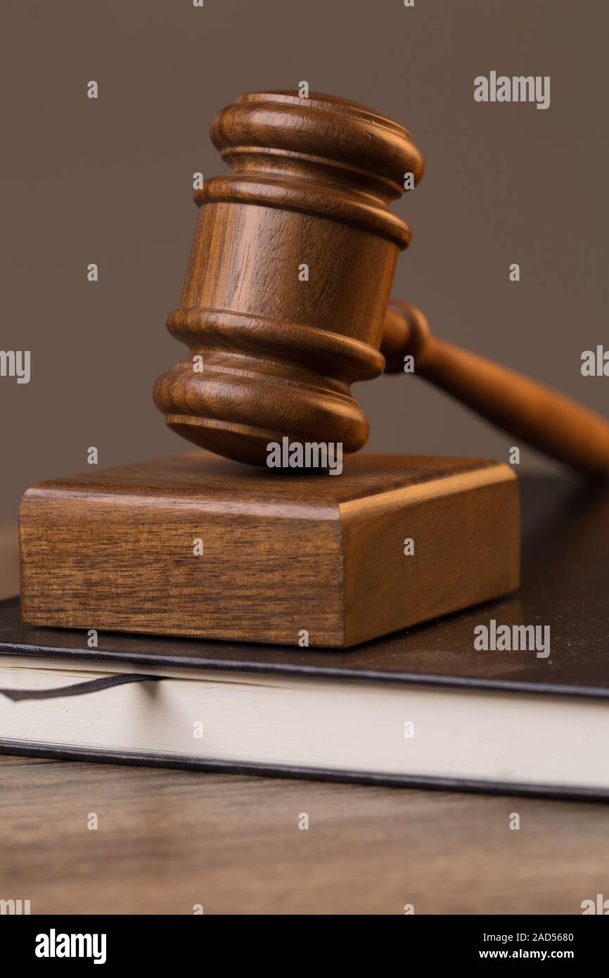 Photo of hammer on book Stock Photo - Alamy