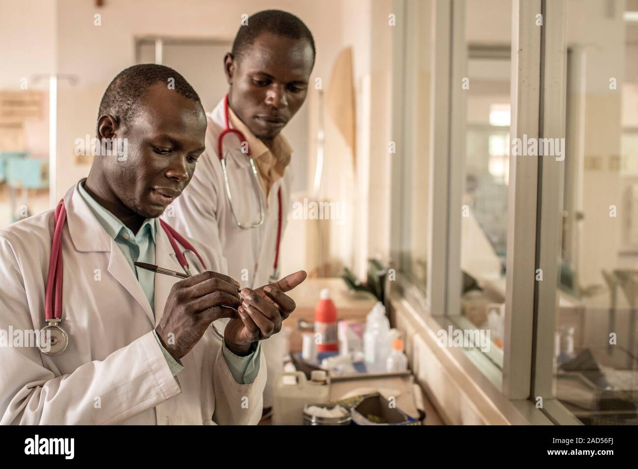 Labelling medical sample. Doctor labelling a medical sample in a ...